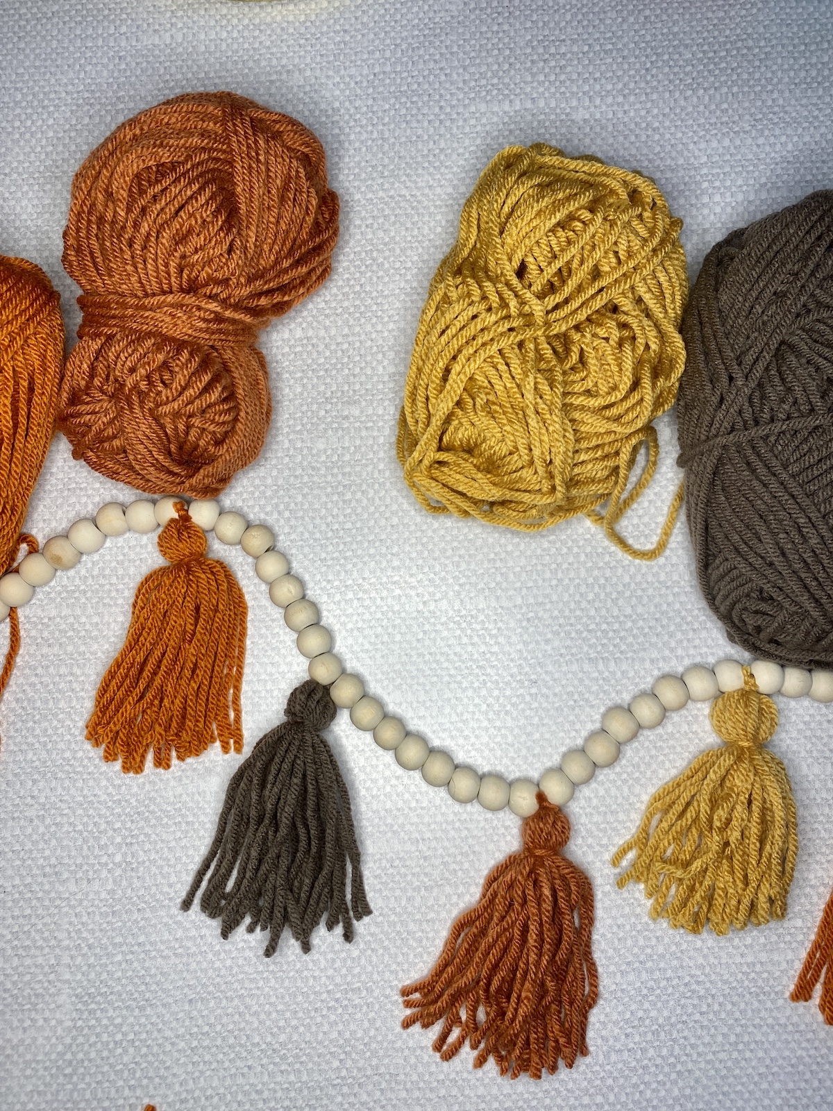 DIY Tassel Garland With Yarn & Wooden Beads - Hootshack